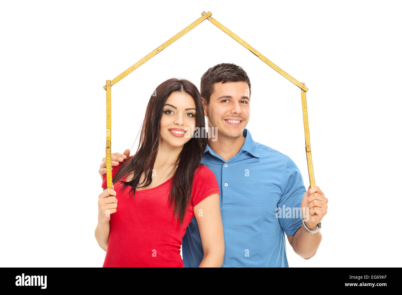 Couple making roof over their head with tape measure isolated on white ...