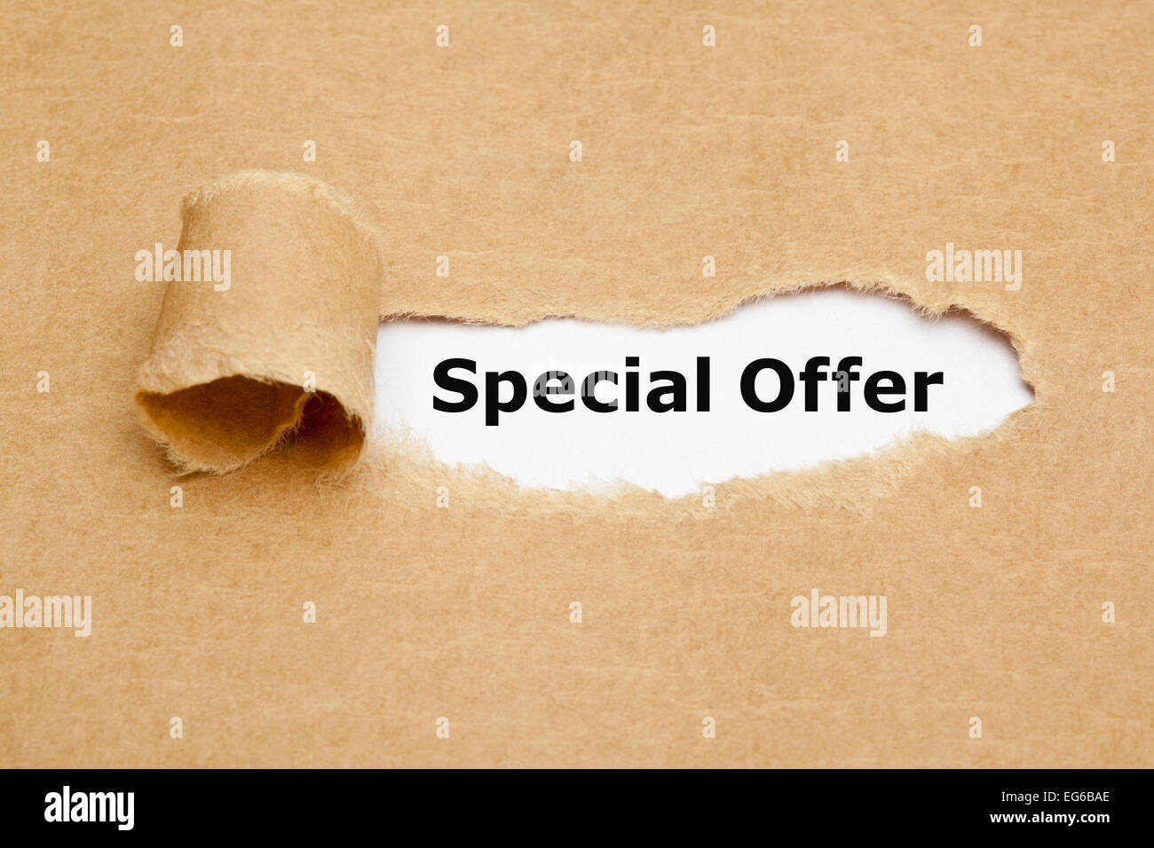 Special Offer appearing behind torn brown paper Stock Photo - Alamy