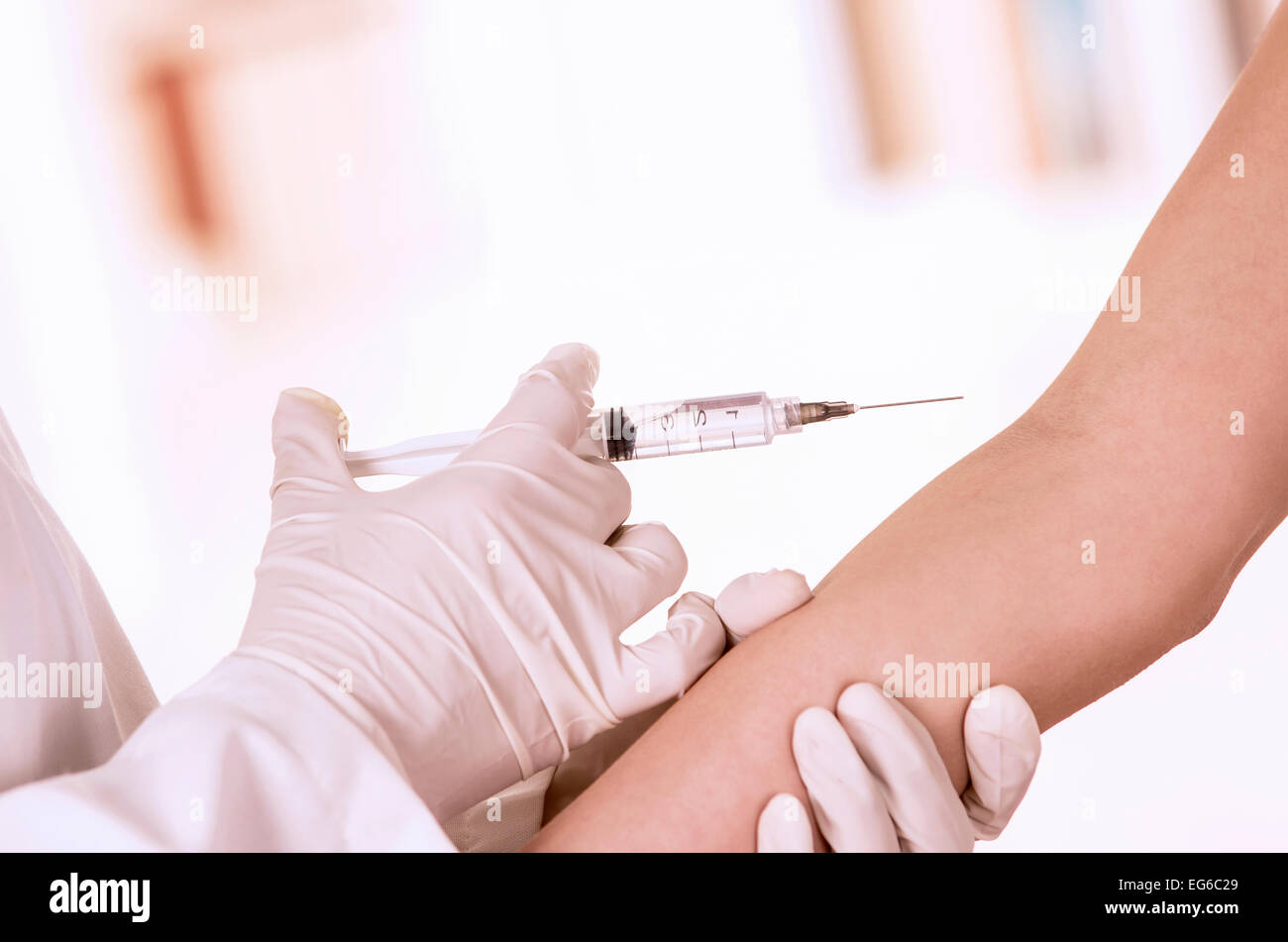 closeup of doctor's hand with injection holding patients arm Stock ...