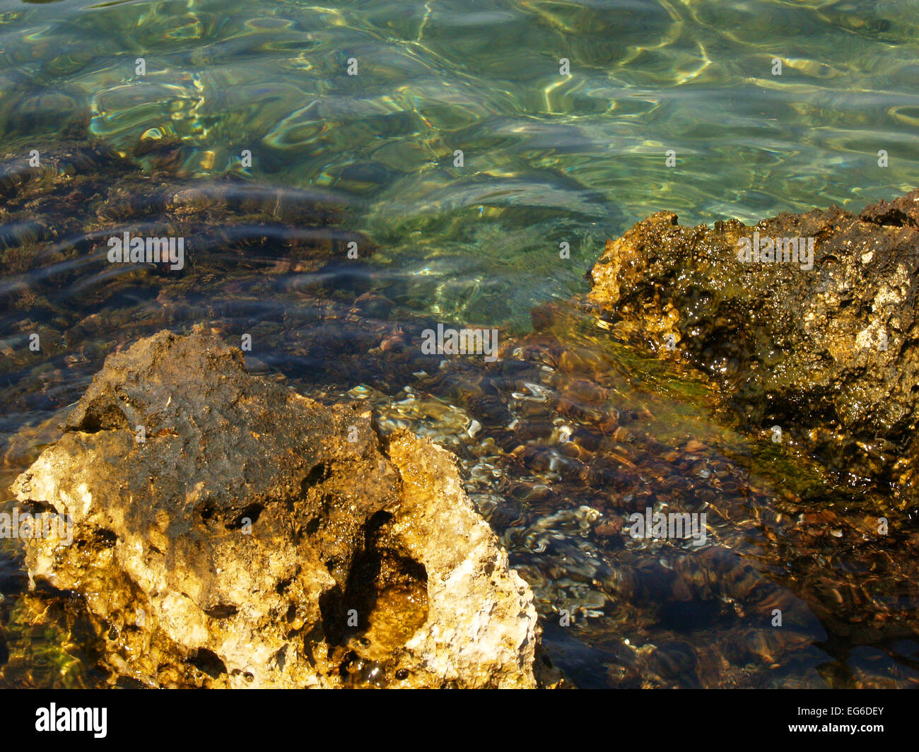 Green and blue transparent waves and rock Stock Photo - Alamy