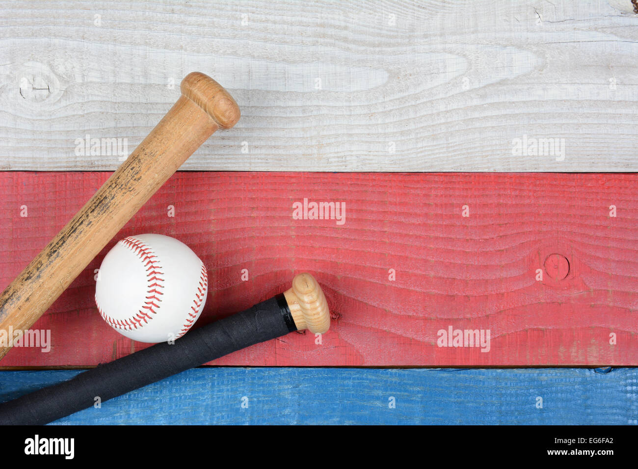 High angle shot of a baseball and bats on a red, white and blue picnic ...