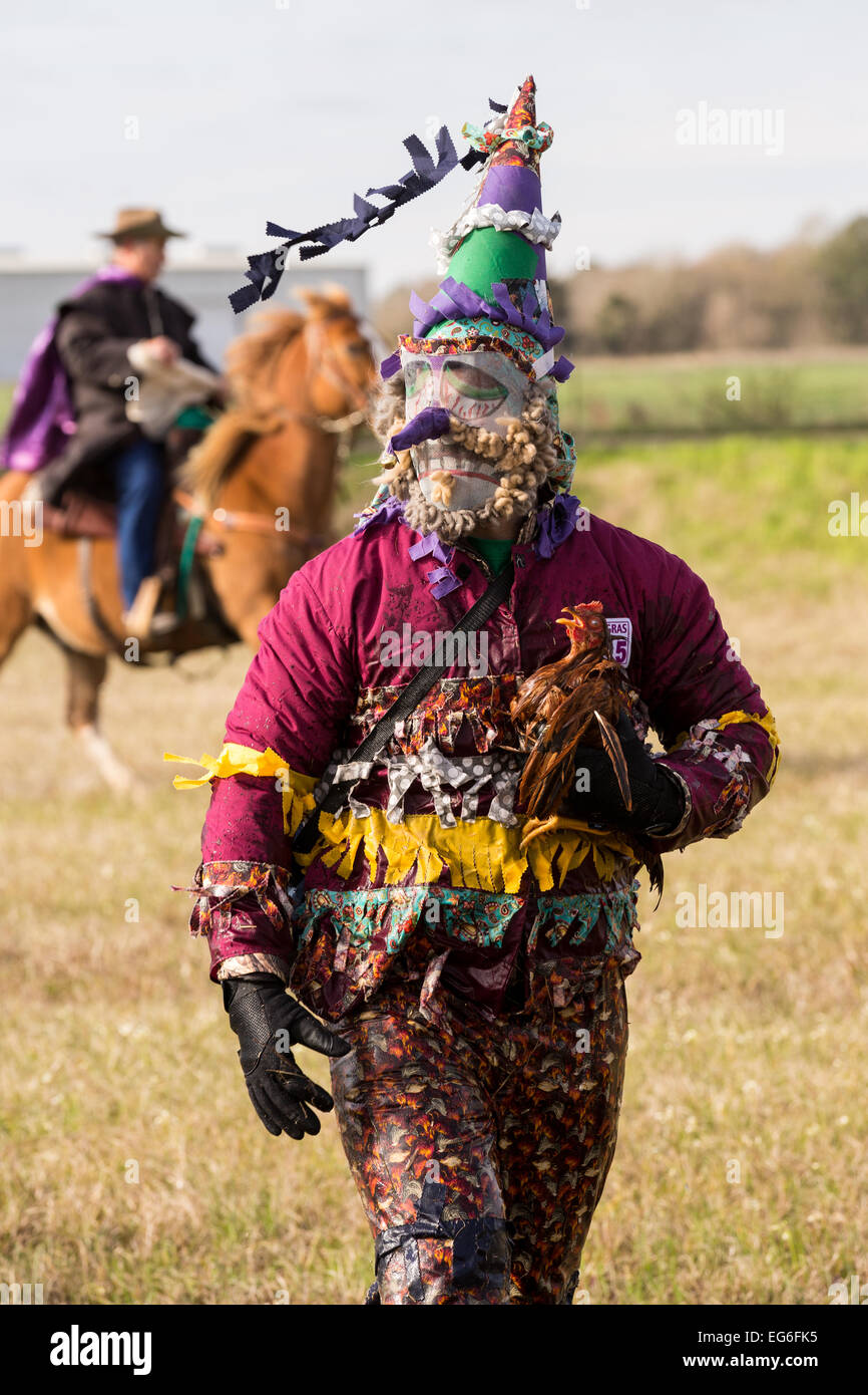 A reveler carries the chicken he just caught during the traditional ...