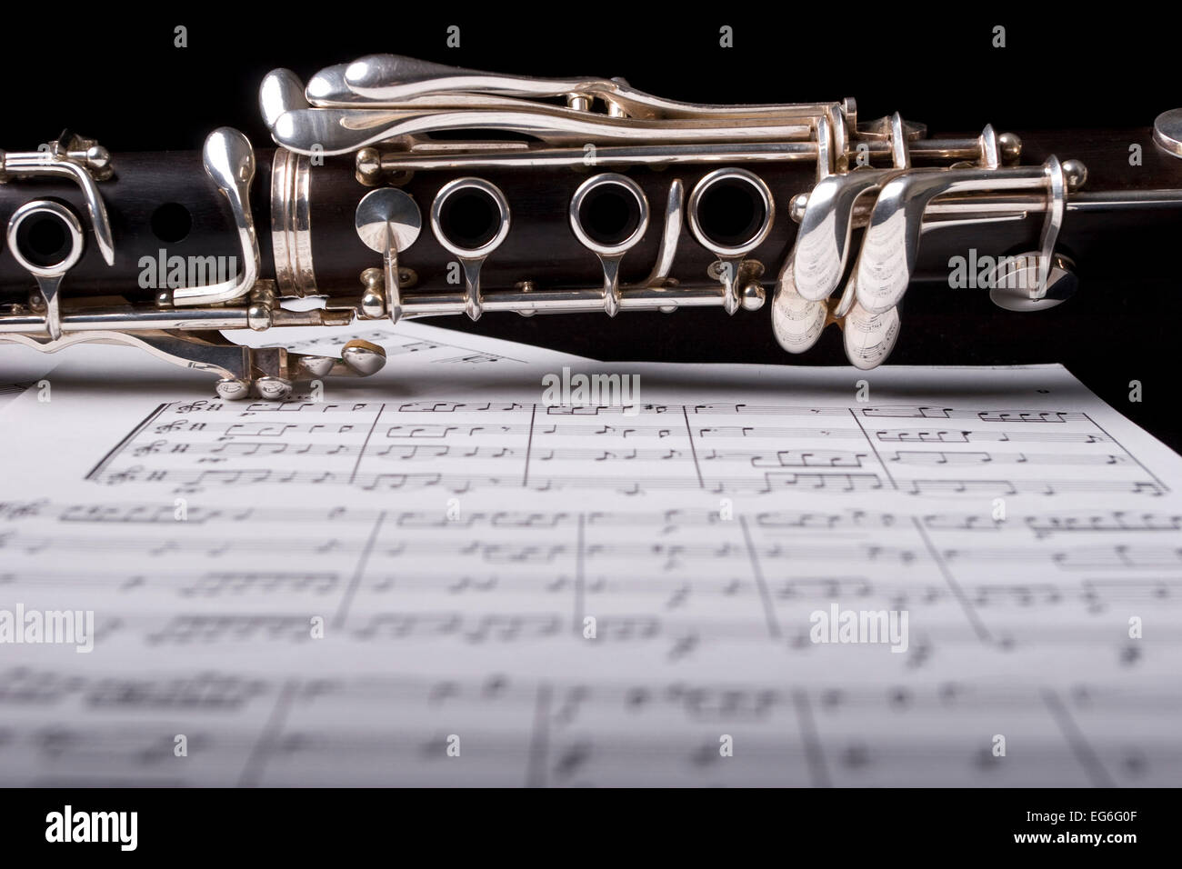 Photograph of a clarinet isolated over sheet music Stock Photo - Alamy