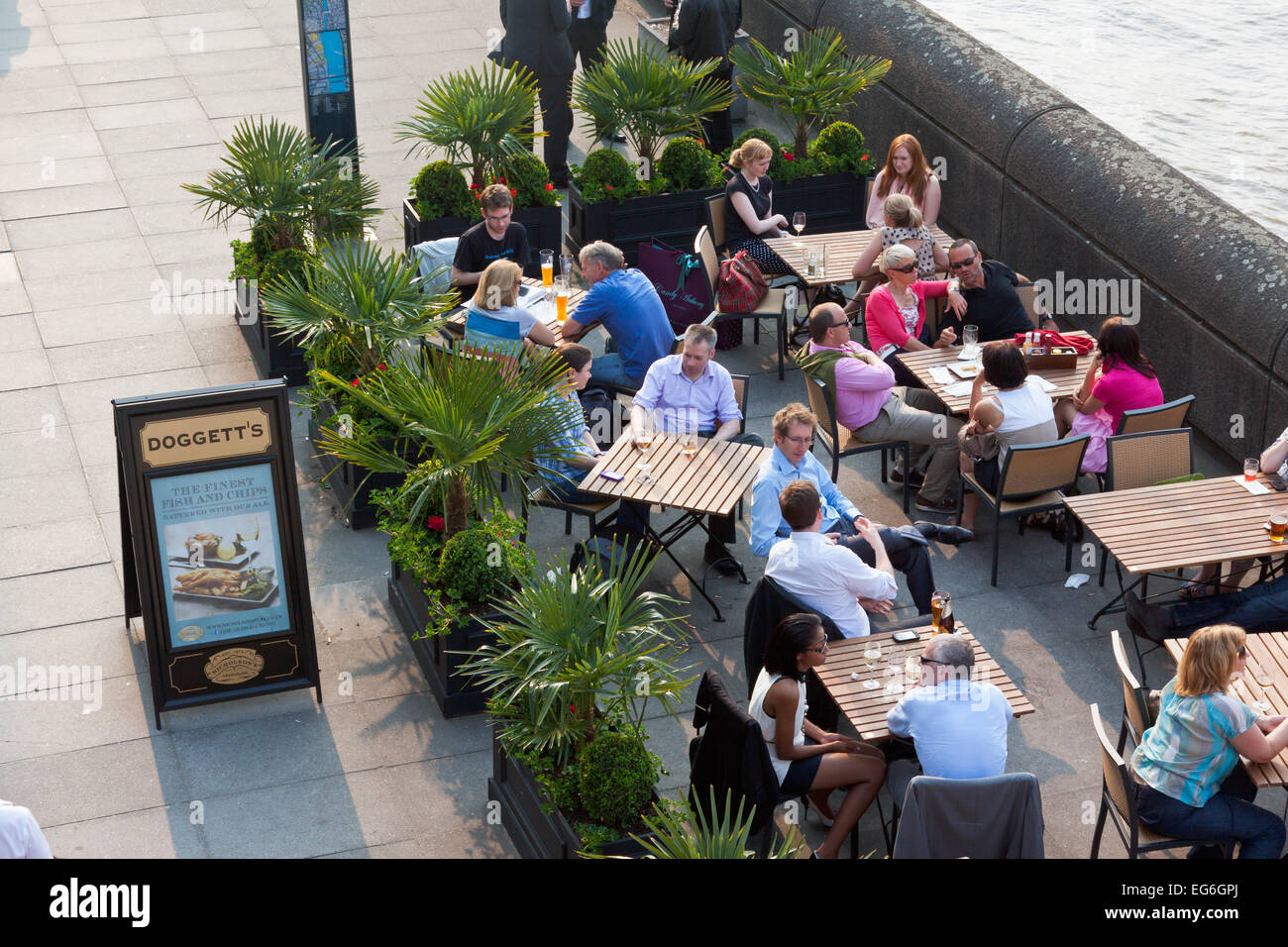People sitting outside Doggetts Coat & Badge pub on a warm afternoon on ...