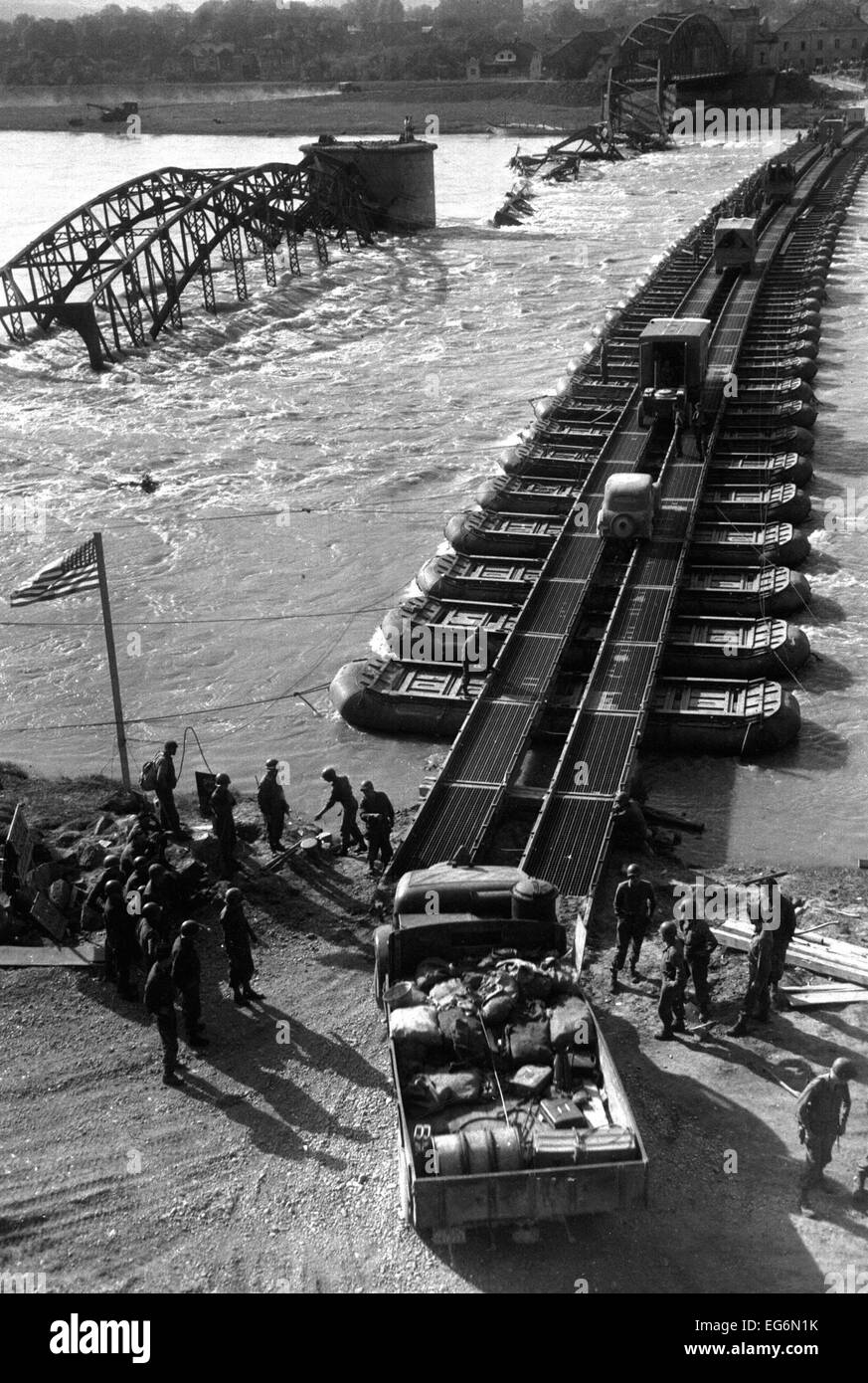 German soldiers cross a pontoon bridge from Branau, Austria to Simbach ...