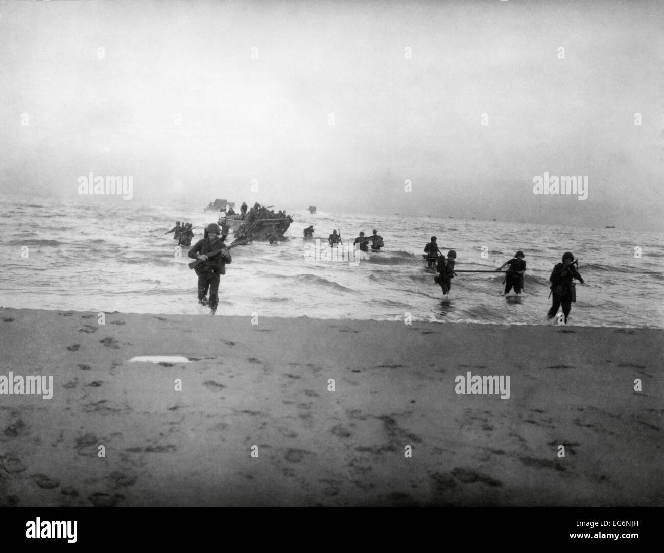 143rd Infantry regiment Combat Team running onto a beach on the Gulf of ...