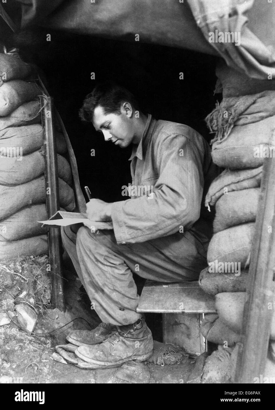 U.S. soldier writes a letter during a break along the fighting front in ...