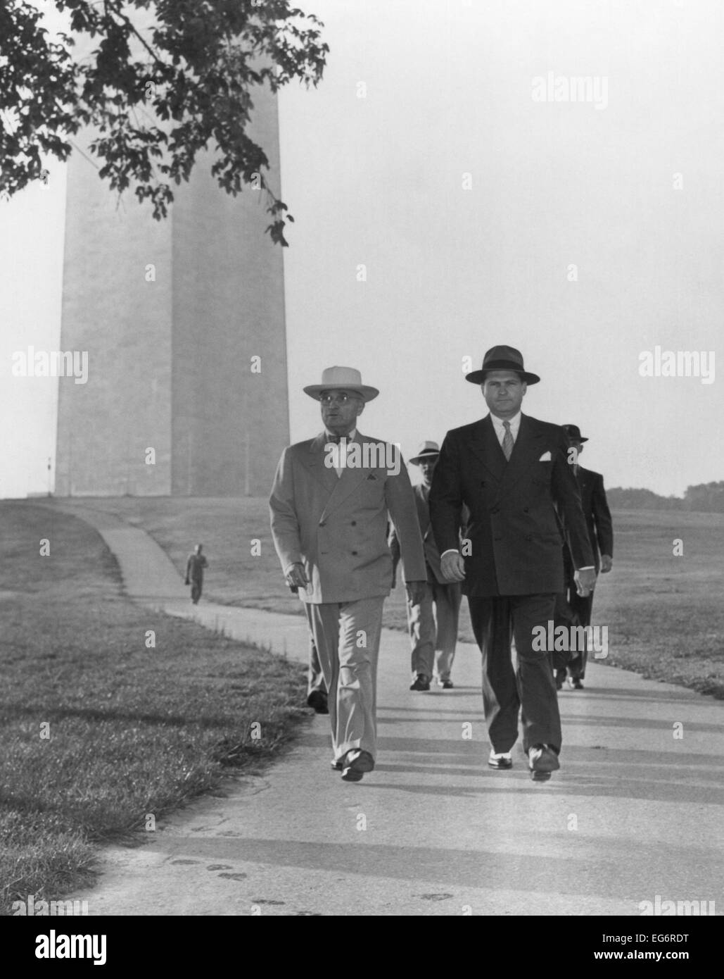President Harry Truman and Secret Service men on a walk near the White ...