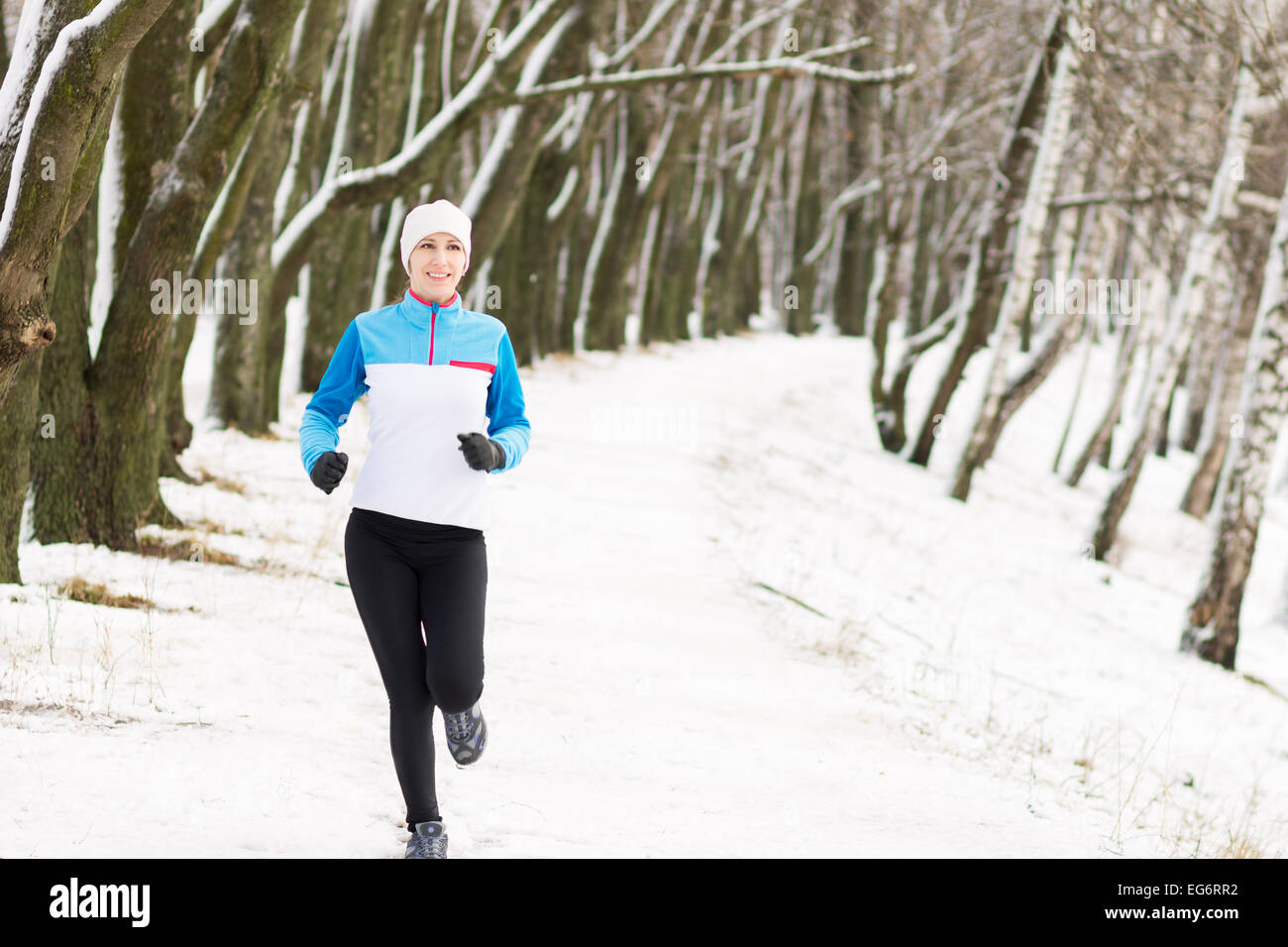 Cheerful young sport woman at winter outdoor activity. Smiling ...
