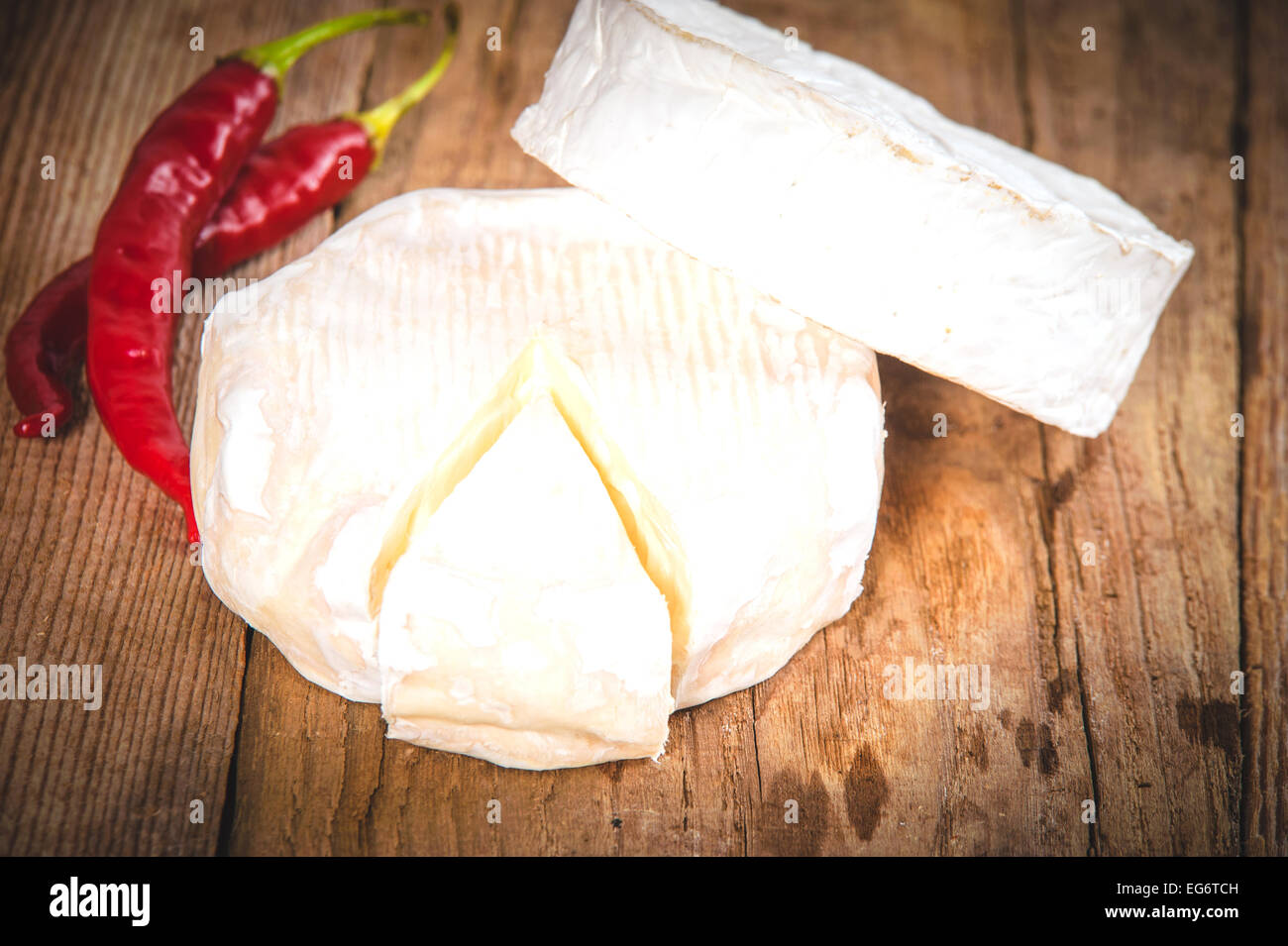 Smelly blue cheese on a wooden rustic table with hot chili pepper Stock ...