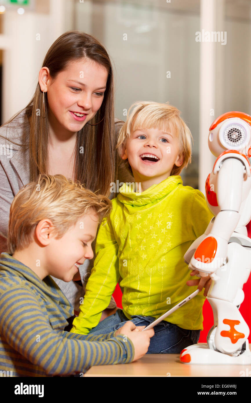 Young children playing with humanoid robot during school time Stock ...