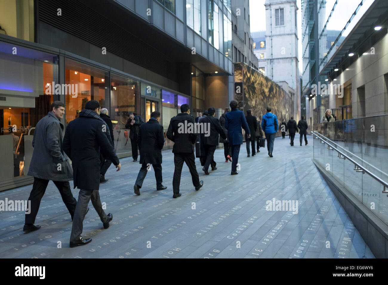 Workers in the City of London walk home past their offices in the ...