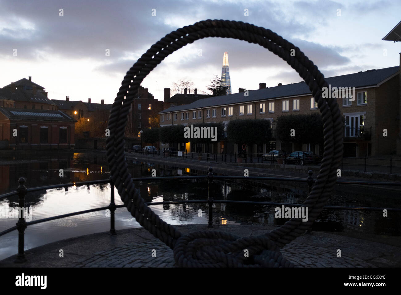 View looking across the old waterway in Wapping to the skyline of Tower ...