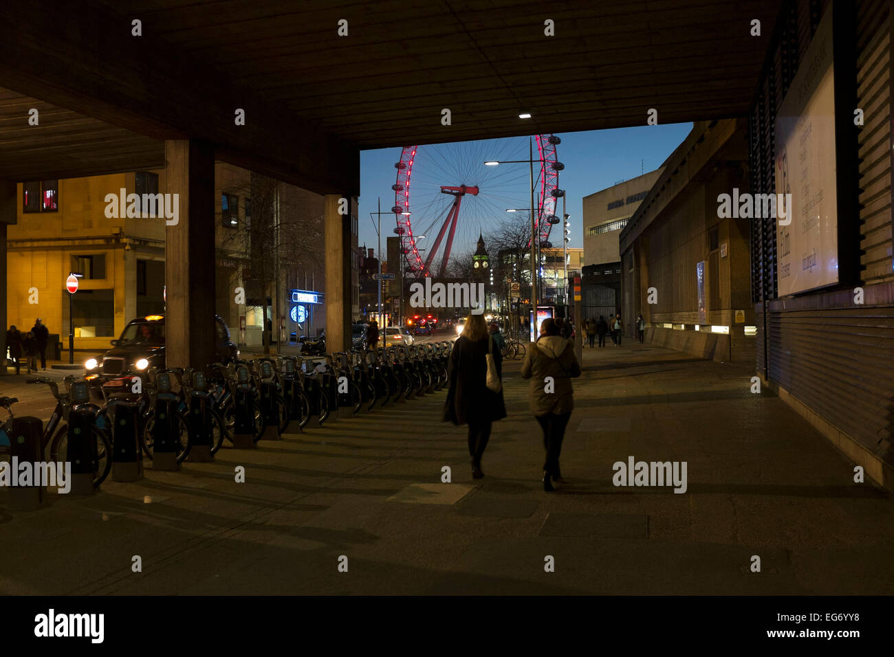 View of the London Eye at night from underneath Waterloo Bridge, London ...