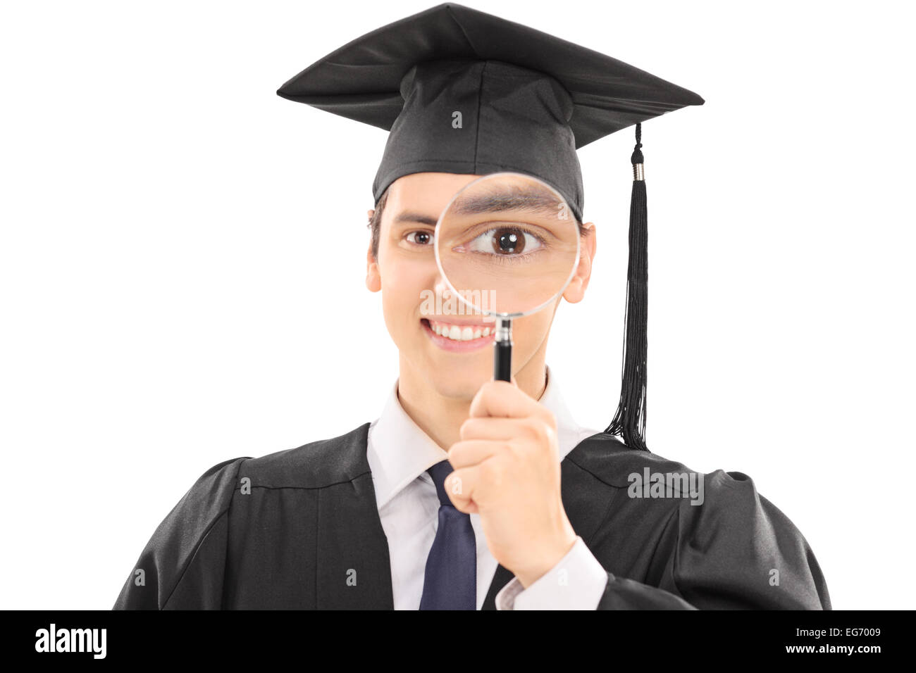 College graduate looking through magnifying glass isolated on white ...