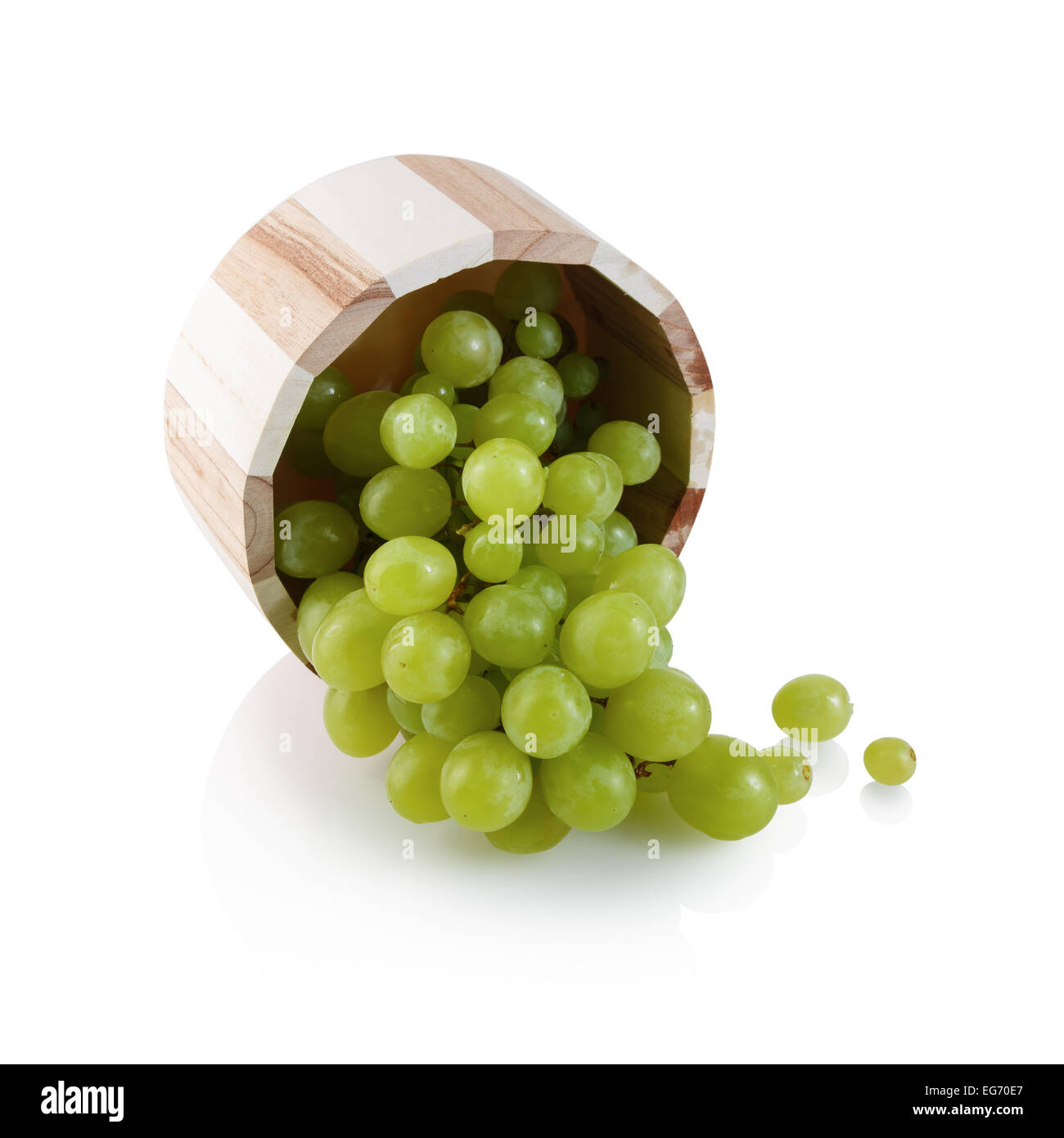 Green grapes in a small wooden tub on white background. Isolated with ...