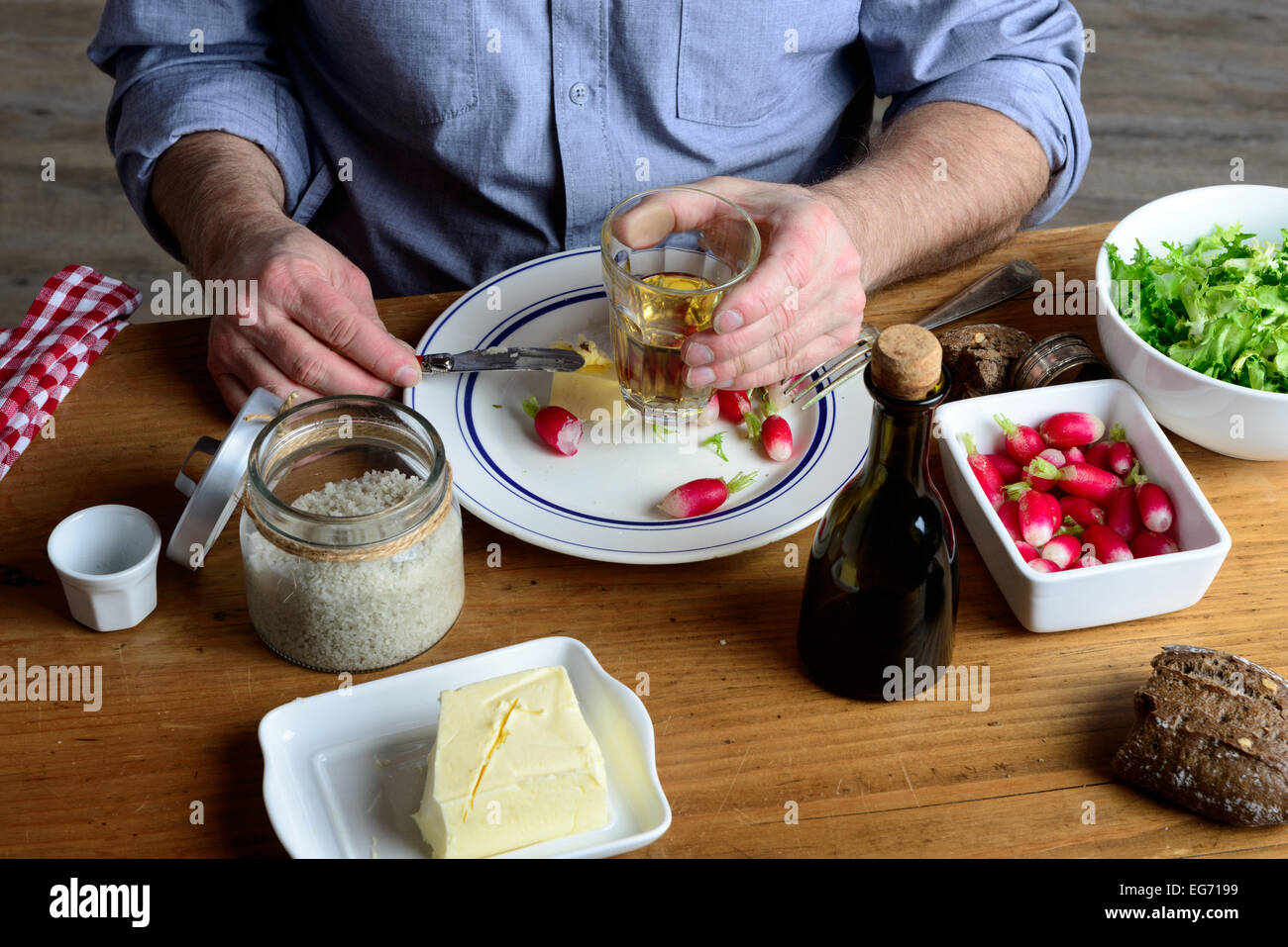 a man eat radishes with butter and salt and drink cider Stock Photo - Alamy