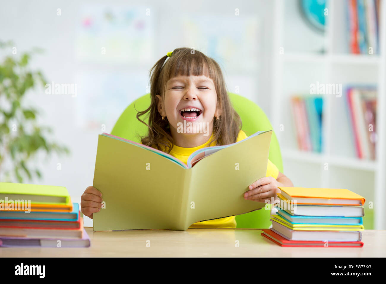 Happy child with opened book Stock Photo - Alamy