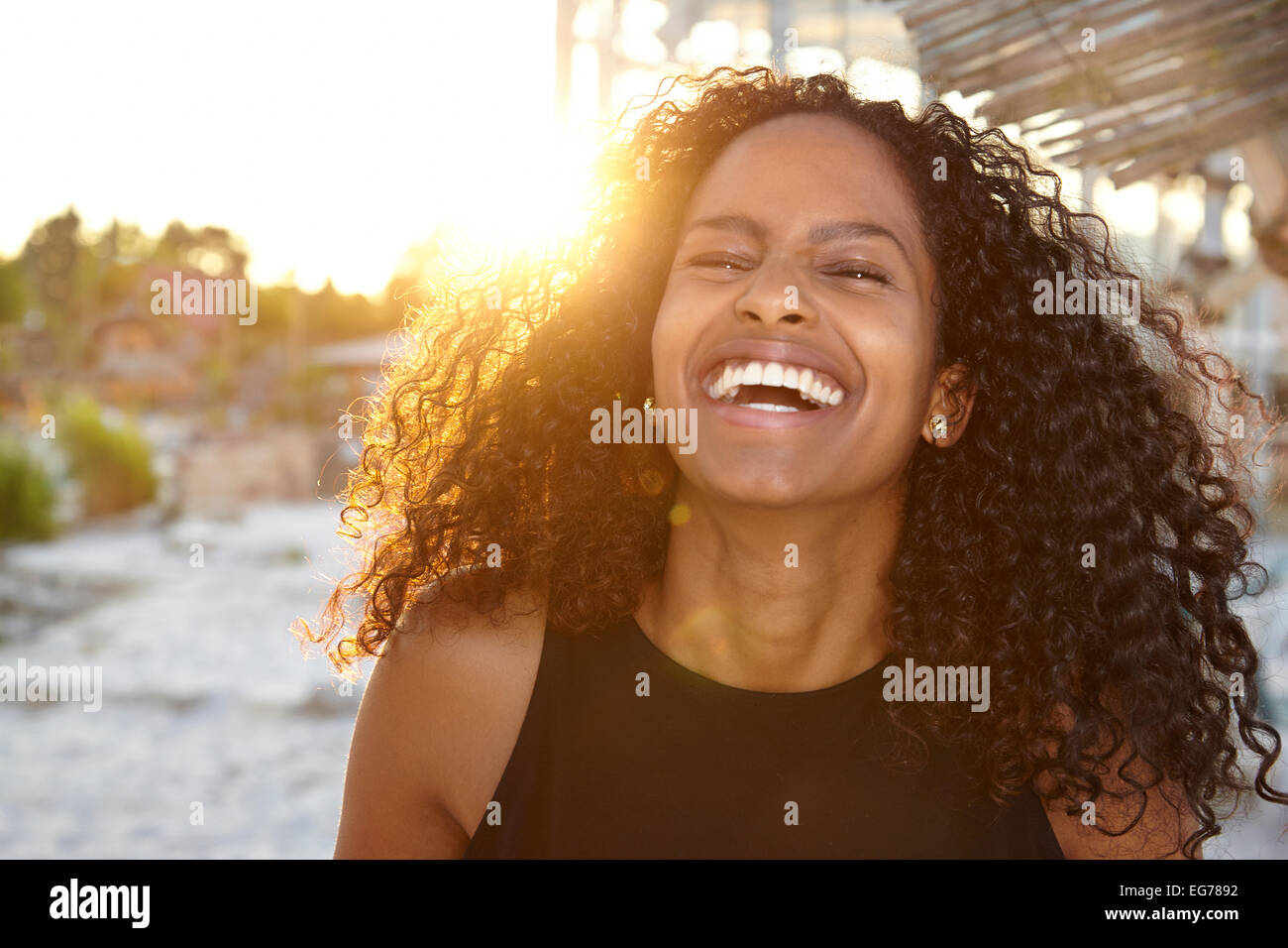 Portrait of laughing woman in backlight Stock Photo - Alamy