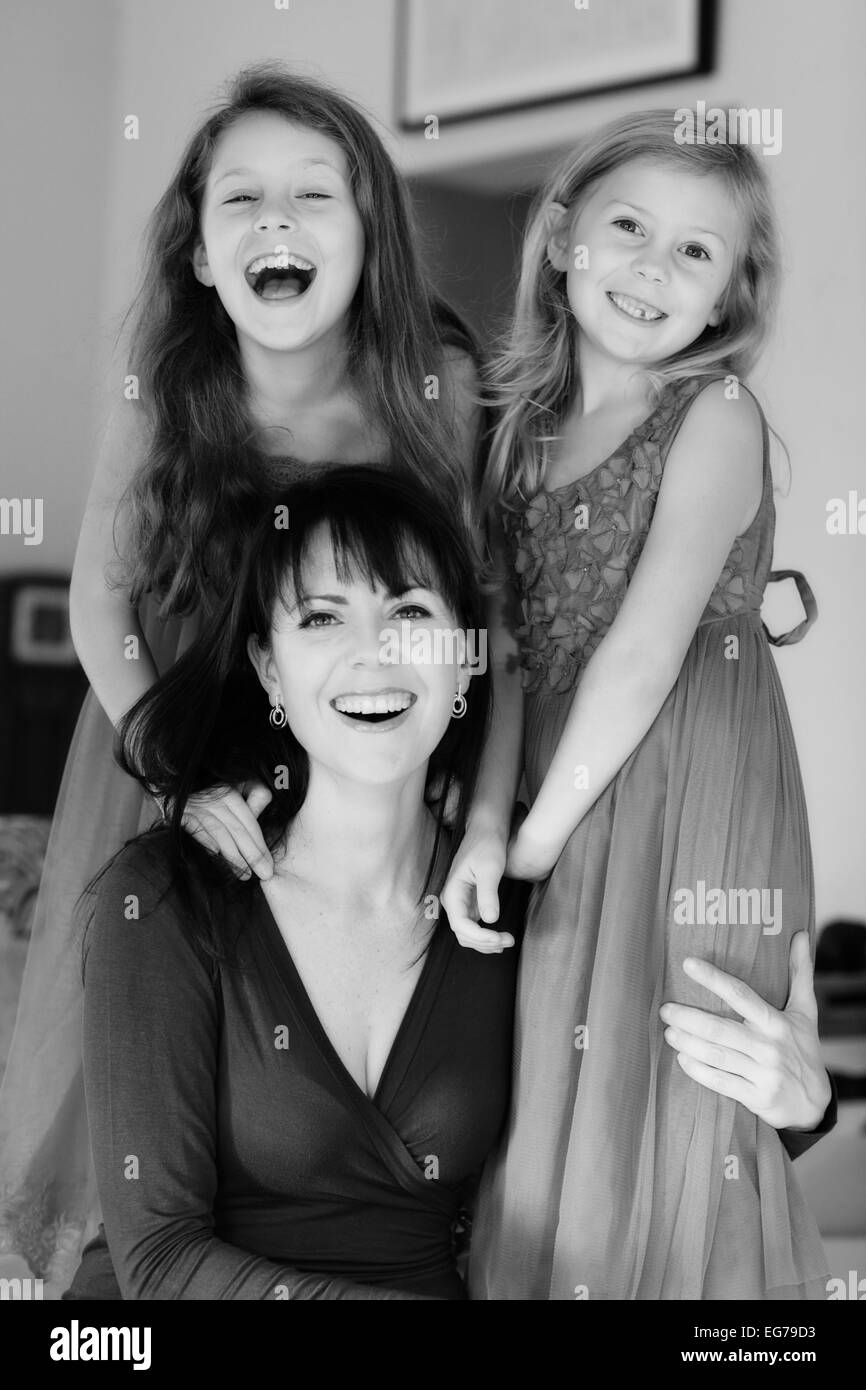 Single mom and her two pretty daughters in black and white Stock Photo ...