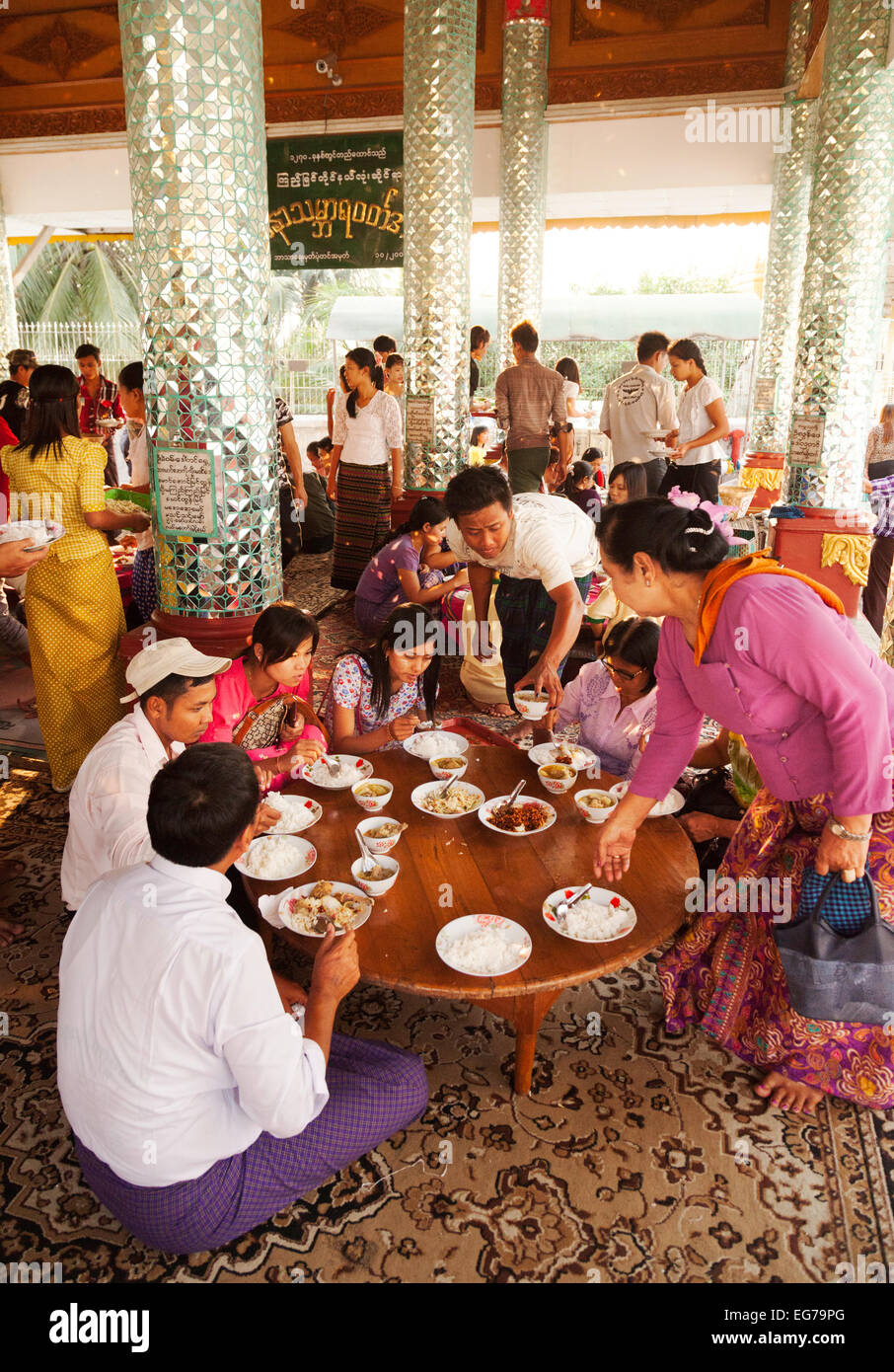A Burmese family eating a meal at a religious ceremony; the Shwedagon ...