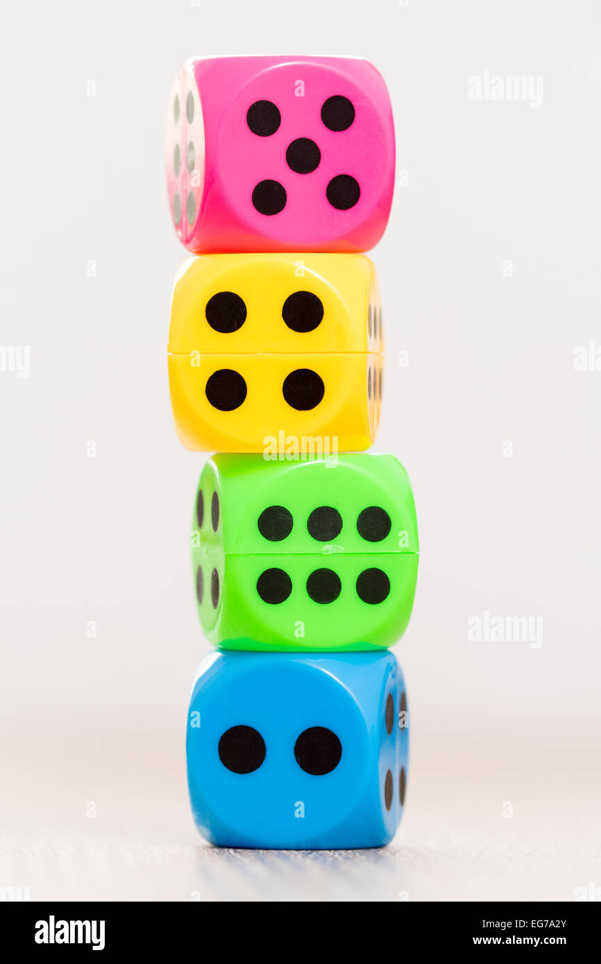 Stack of colorful dice, isolated on blurry background Stock Photo - Alamy