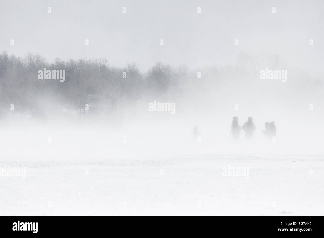 Ice fishermen out on a frigid winter day with howling winds on one of ...