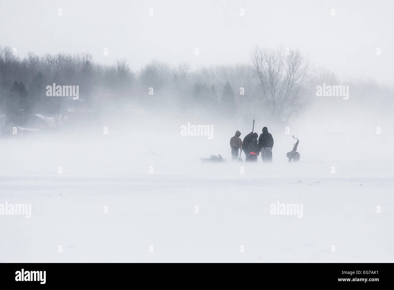 Ice fishermen out on a frigid winter day with howling winds on one of ...