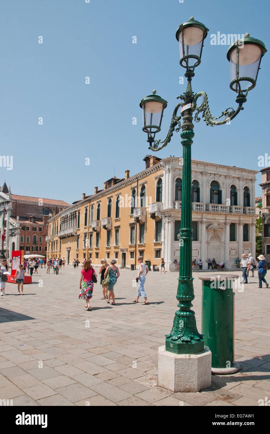 Elegant street lamp stand with three lights and pedestrians in Campo ...