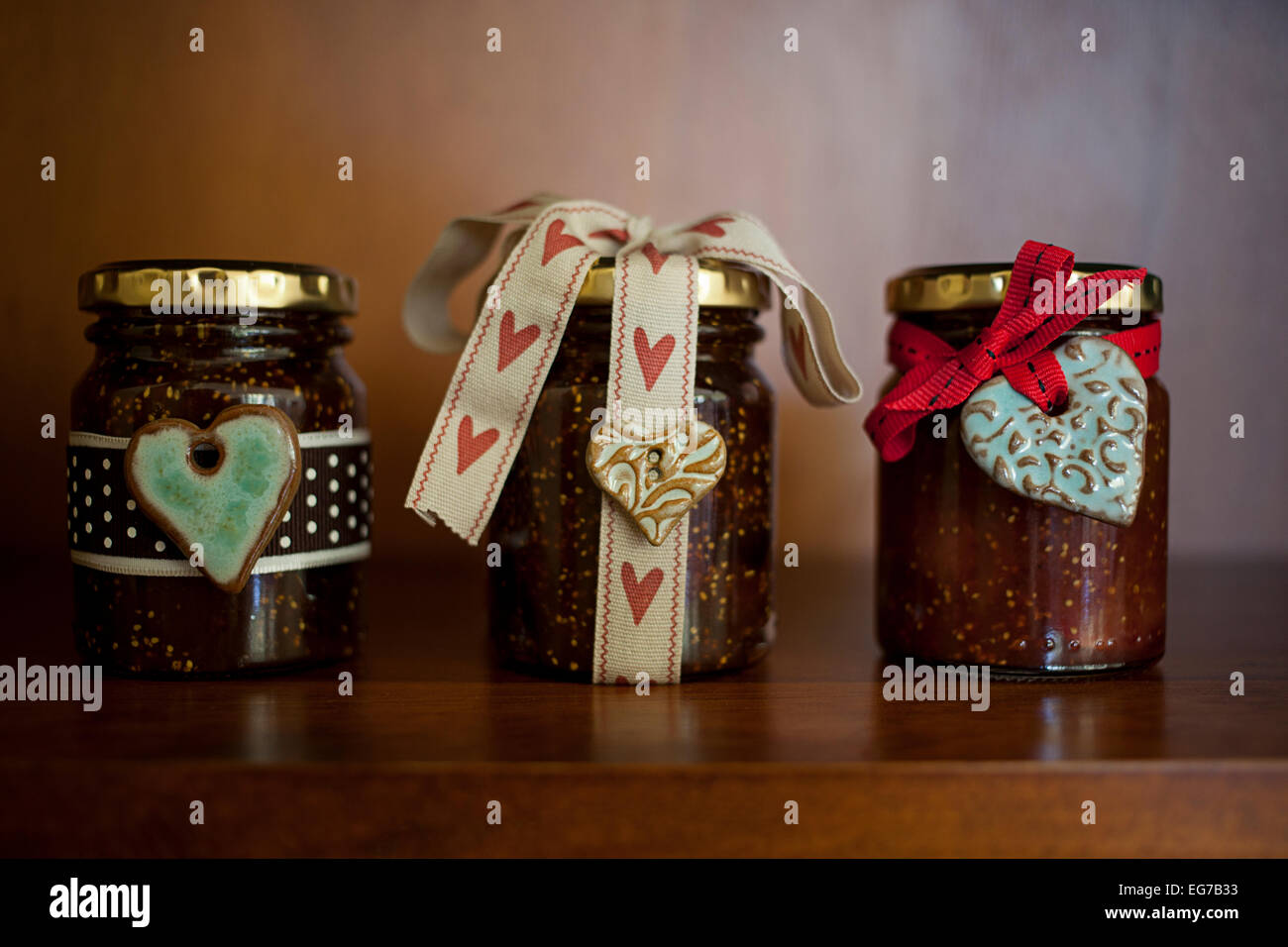 Three jam jars on a shelf Stock Photo - Alamy