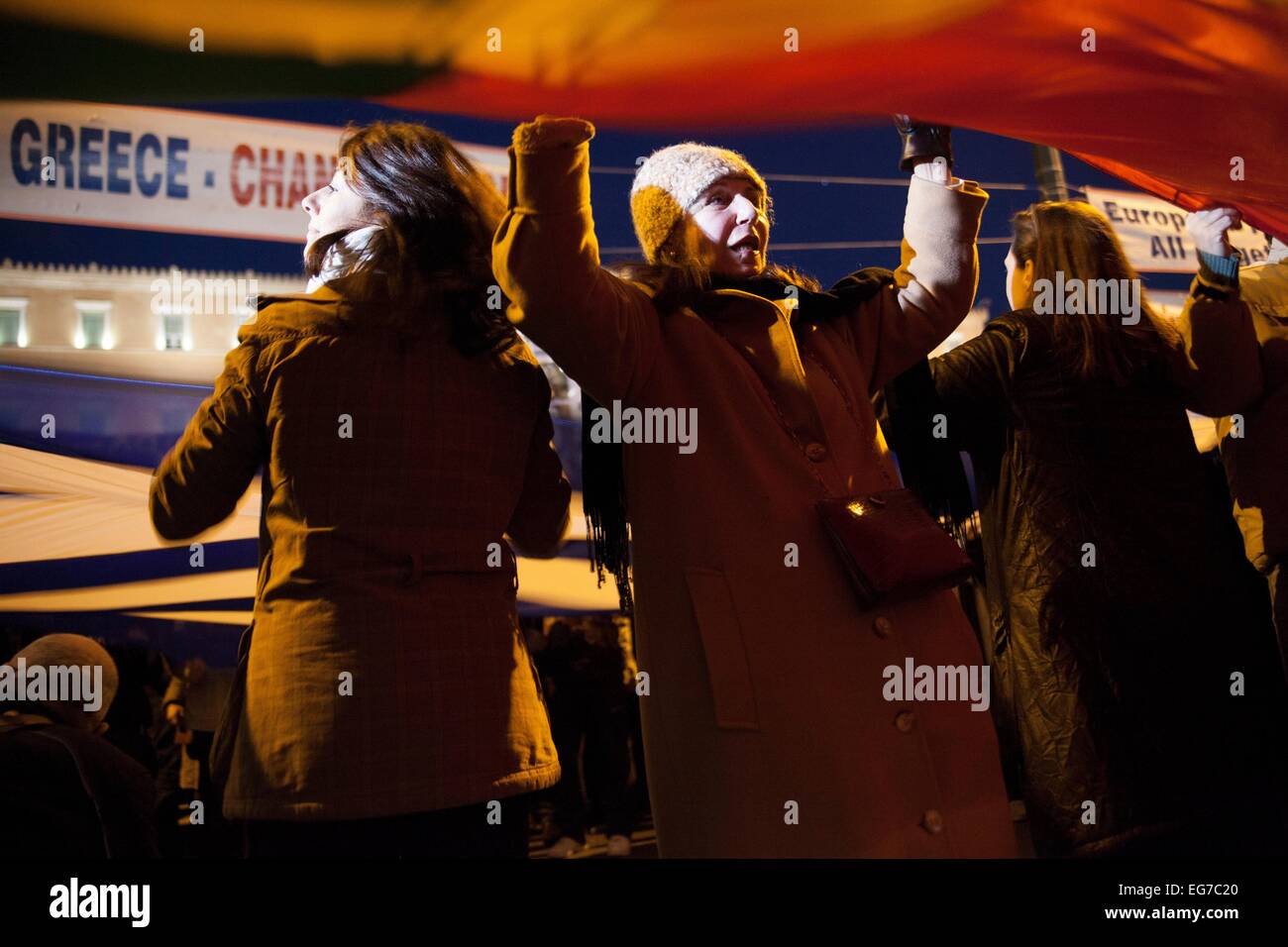 Greek woman and flag and banner "Greece Change Europe" during support ...