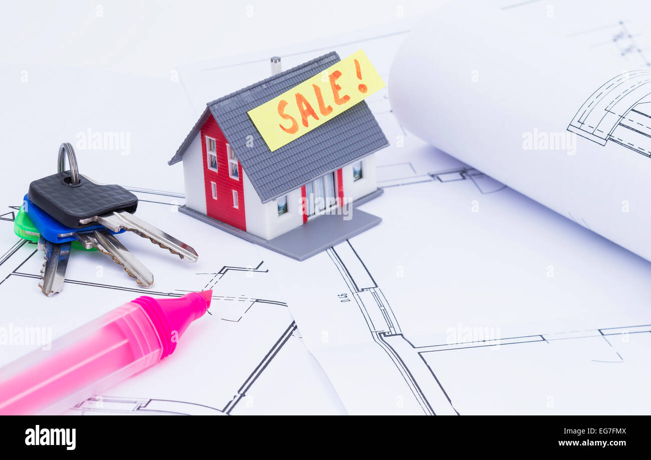 The image shows a house, keys and a architect's plan Stock Photo - Alamy