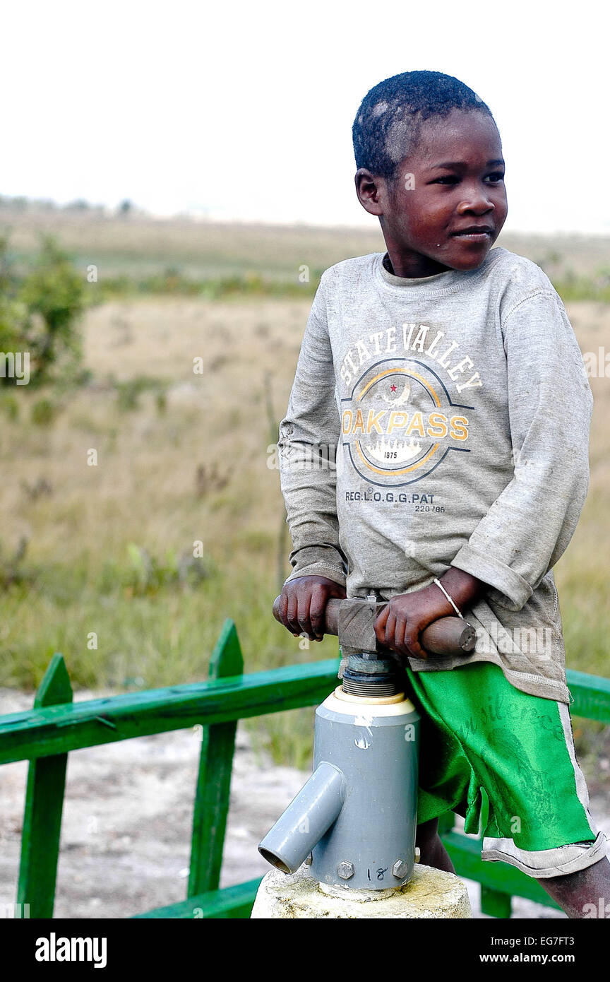 A young boy uses the village well for the first time Stock Photo - Alamy