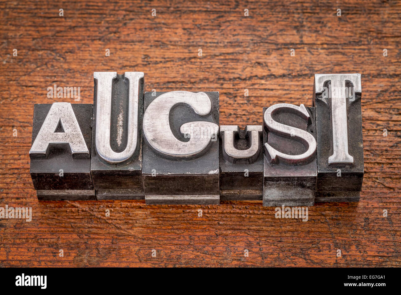 August word in mixed vintage metal type printing blocks over grunge ...