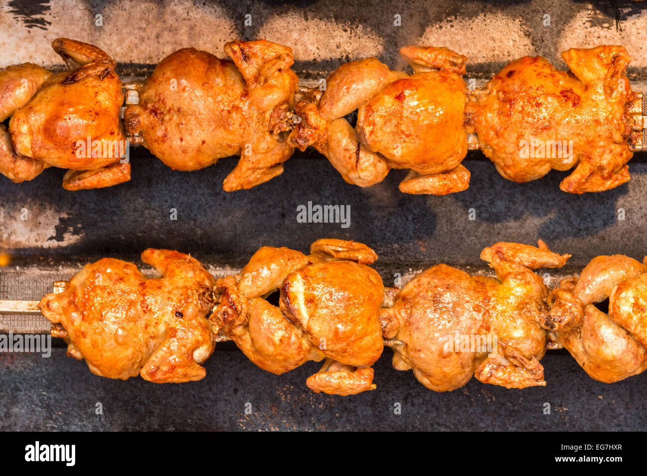 Whole chicken rotate on the grill Stock Photo - Alamy