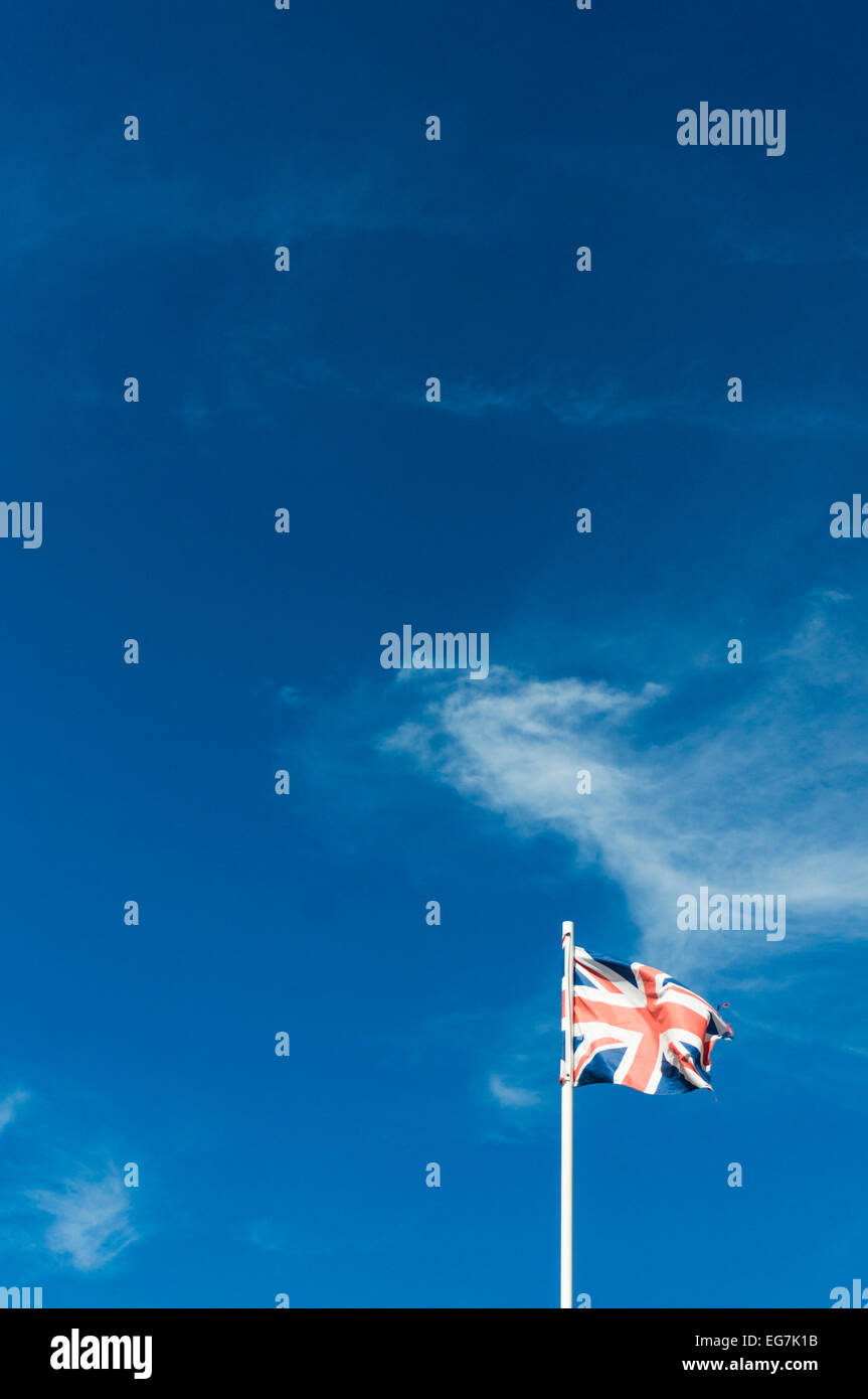 Union Jack flag against a blue sky Stock Photo - Alamy