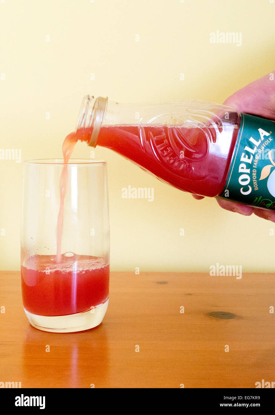 Man Pouring Copella Apple & Raspberry Fruit Juice Drink Into A Glass ...