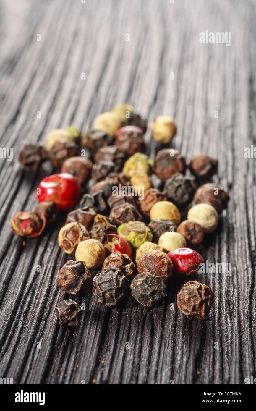 pepper corns on a wooden board Stock Photo - Alamy