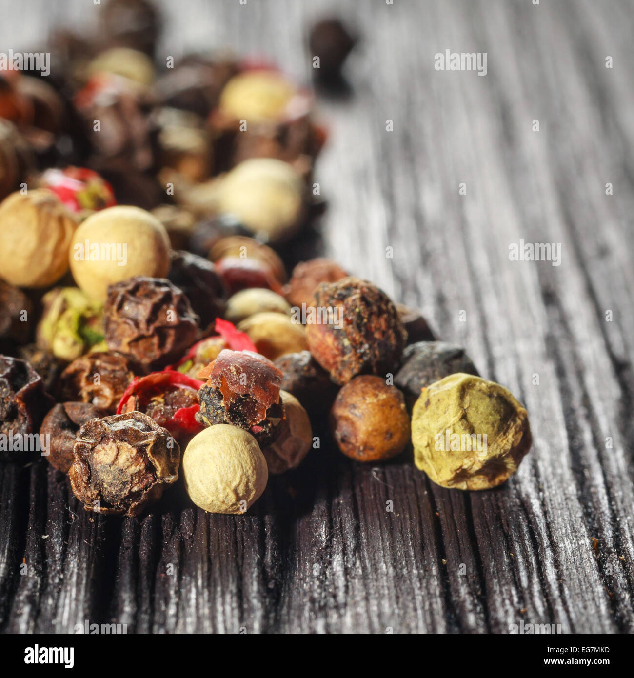 pepper corns on a wooden board Stock Photo - Alamy