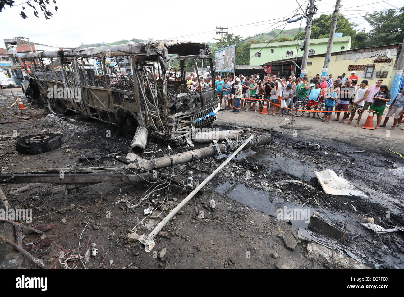 Rio De Janeiro, Brazil. 18th Feb, 2015. Residents look at a burned bus ...