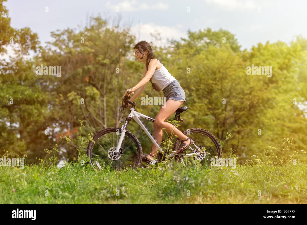 happy slim girl biking in summer park Stock Photo - Alamy