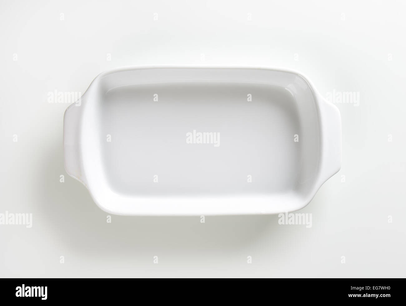 Classic white ceramic baking dish with handles Stock Photo - Alamy