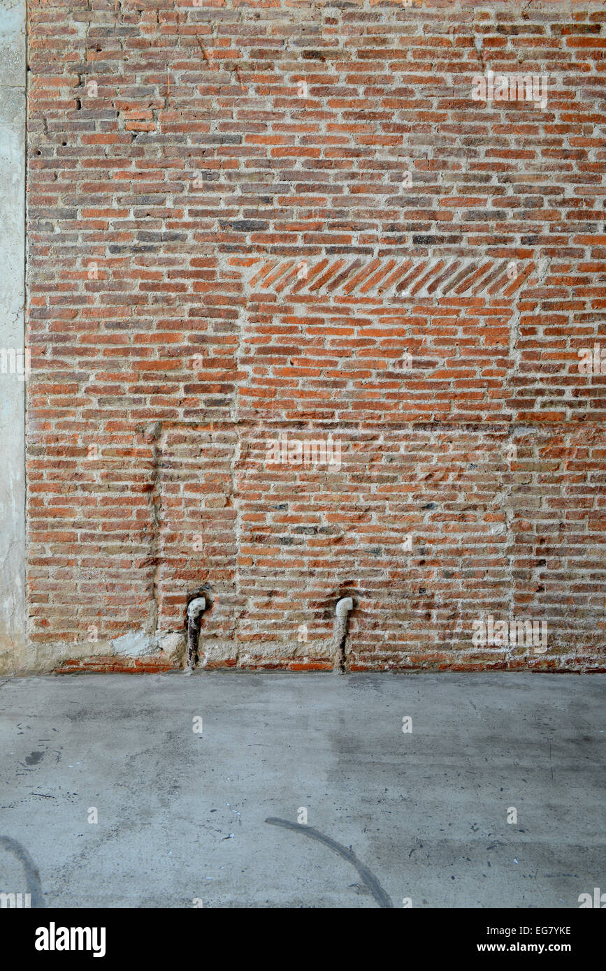 Old brick wall and pipe on concrete texture, background for decorate ...