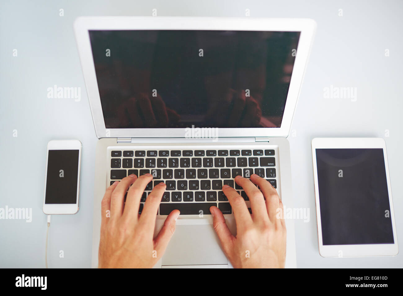 Human hands typing on laptop keypad Stock Photo - Alamy