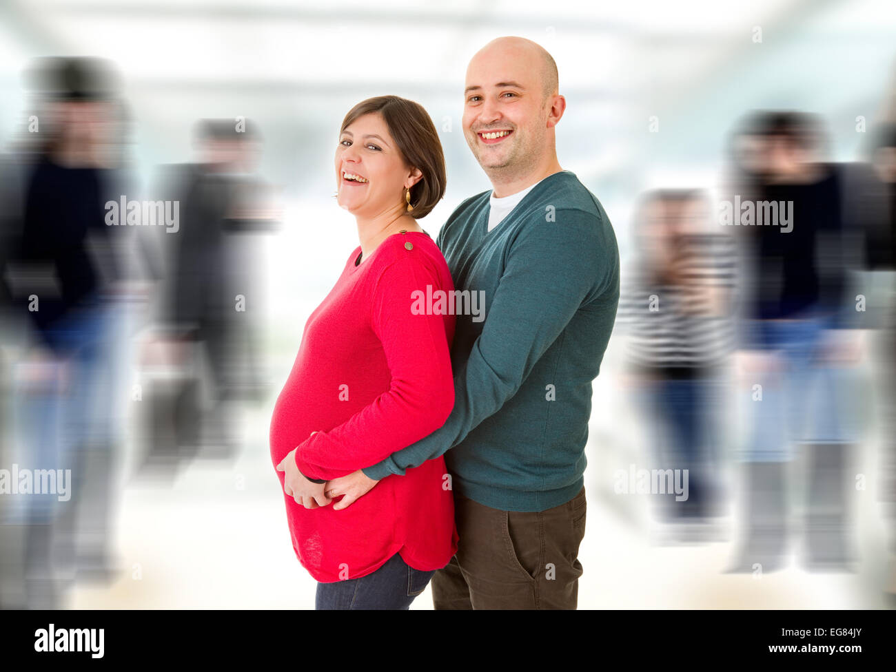 happy pregnant couple posing, studio picture Stock Photo - Alamy