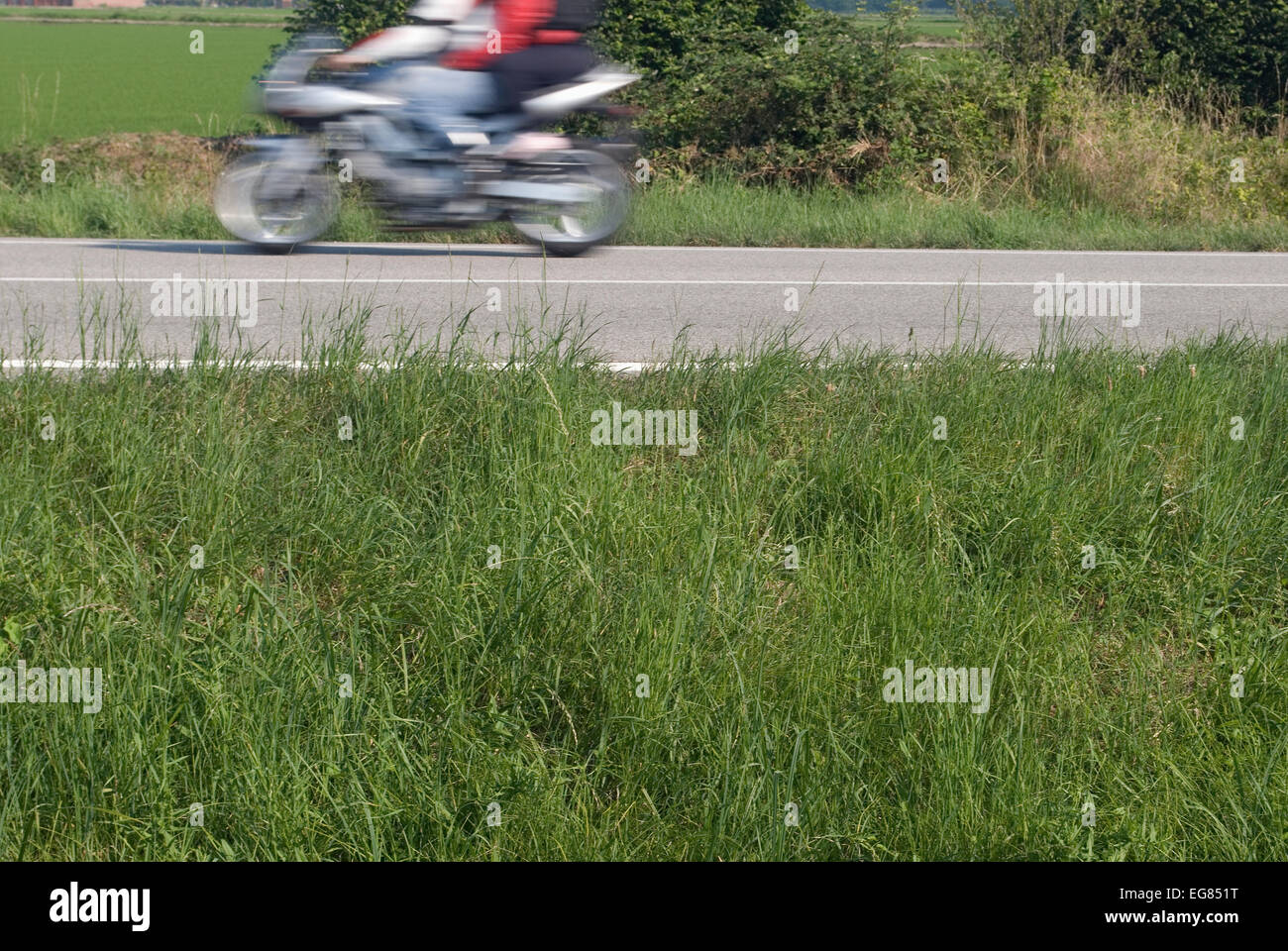 Passing motorbike on country road Stock Photo - Alamy