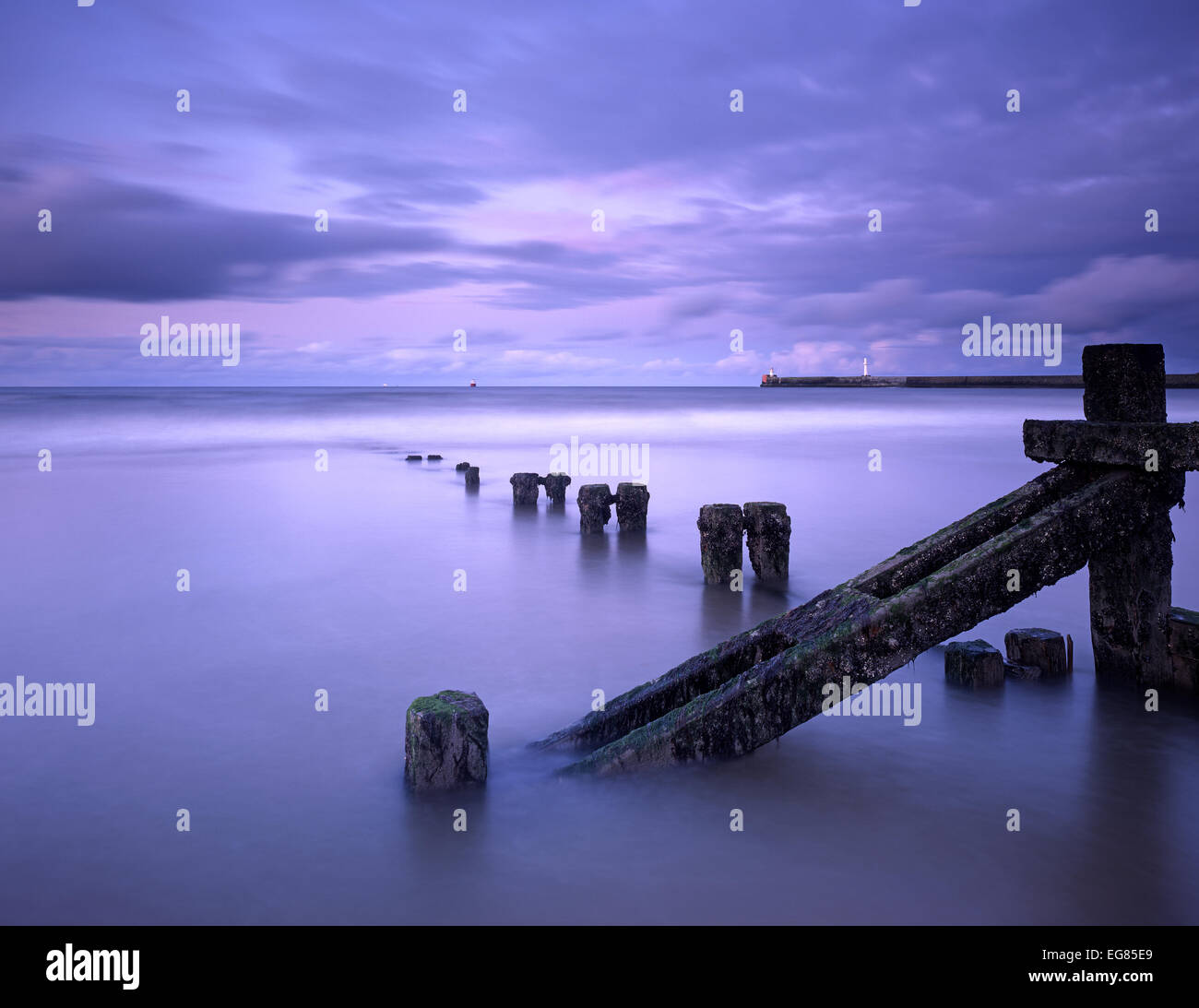 Groyne and harbour wall at Aberdeen seafront at sunset, Aberdeenshire ...