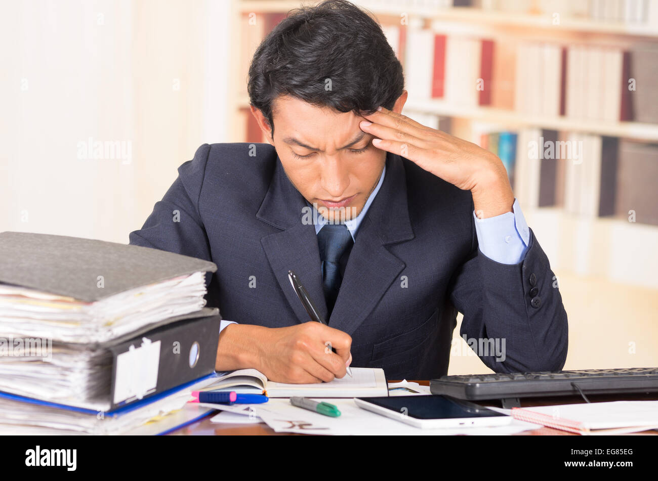 young stressed overwhelmed man with piles of folders on his desk Stock ...