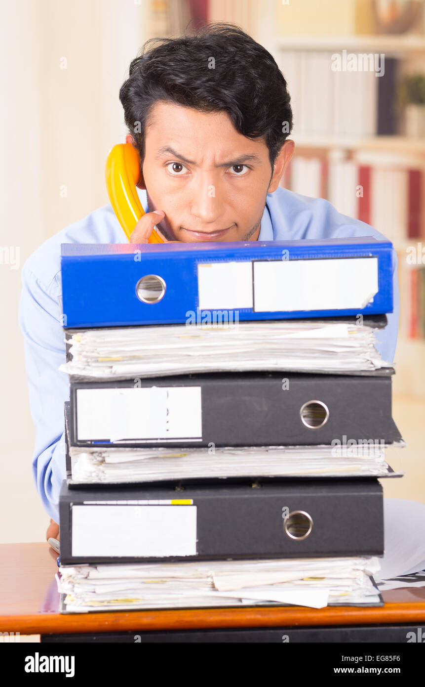 young stressed overwhelmed man with piles of folders on his desk Stock ...