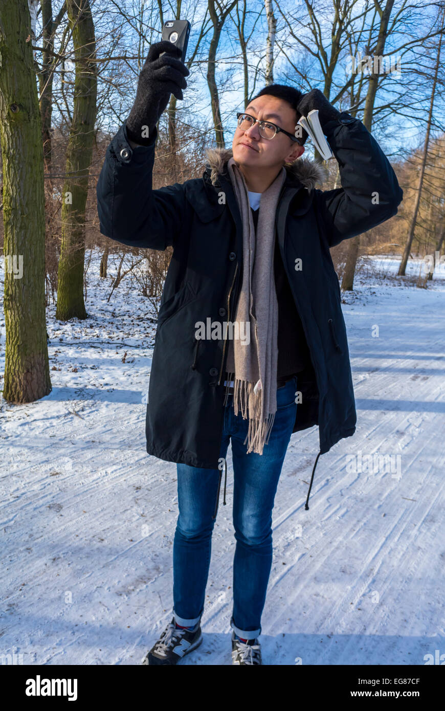 Berlin Germany Europe Chinese Tourist In Coat Taking Selfies Photos With Iphone In German